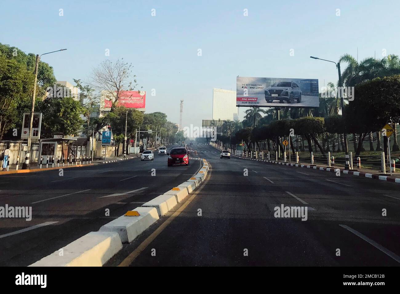Few vehicles drive along Pyay Road, a main avenue that's usually busy ...