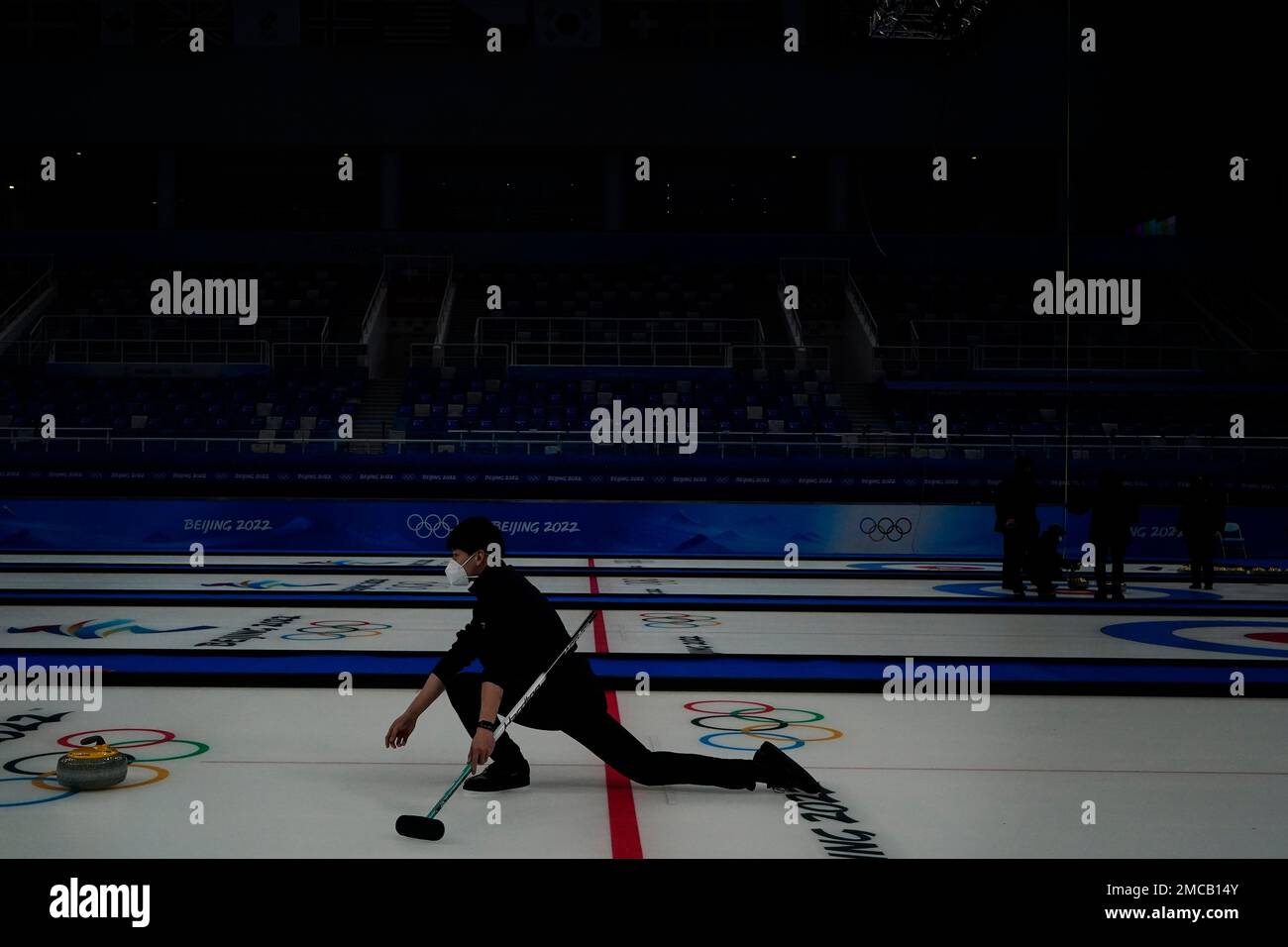 A volunteer tests the curling stones at the curling venue ahead of the ...