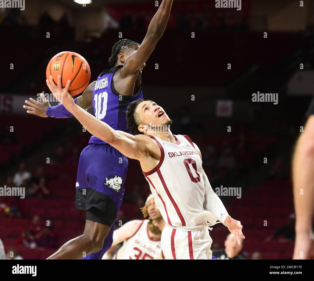 Oklahoma guard Jordan Goldwire (0) goes up for a shot around TCU guard ...