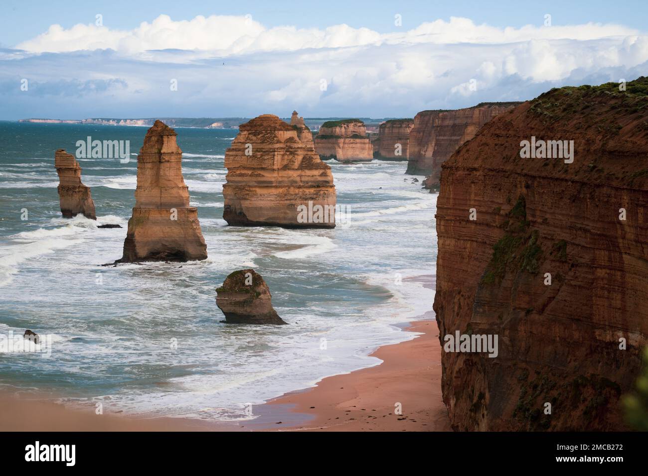 A collection of limestone stacks, The Twelve Apostles, on the sandy ...