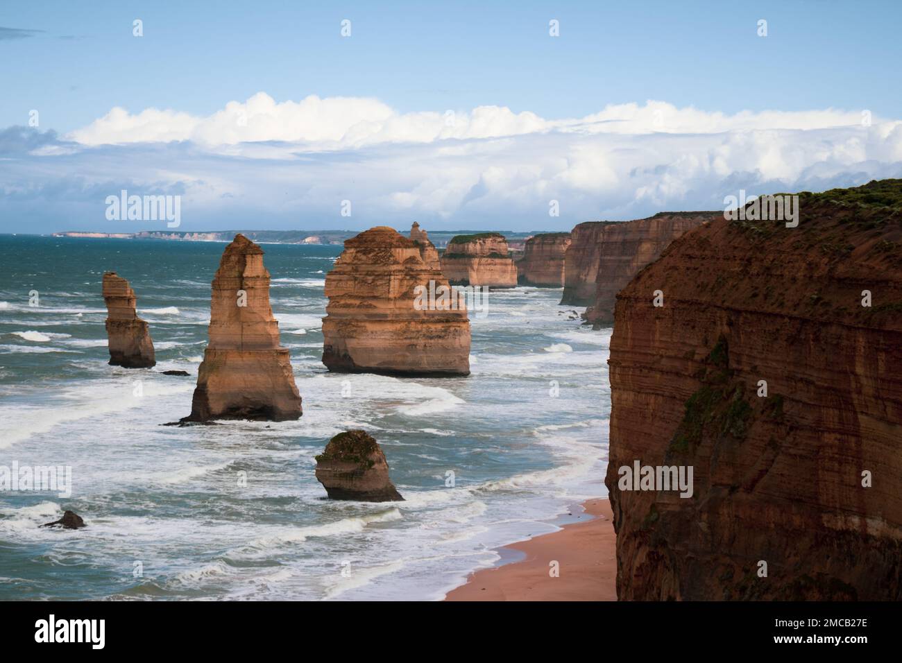 A collection of limestone stacks, The Twelve Apostles, on the sandy ...