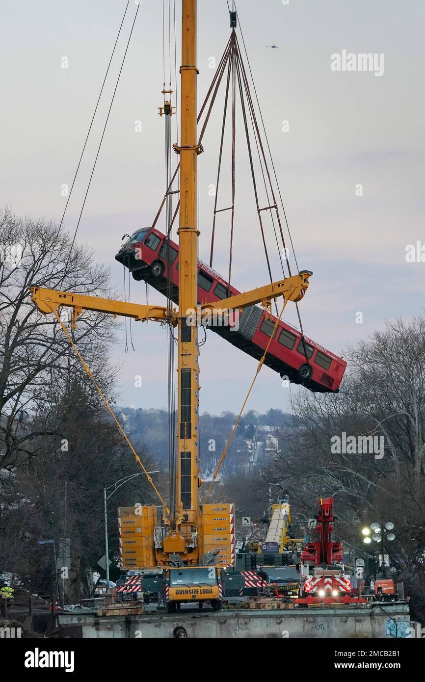 Cranes lift the bus that was on a bridge when it collapsed Friday ...