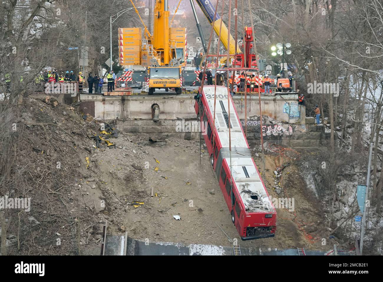 Cranes lift the bus that was on a bridge when it collapsed Friday ...