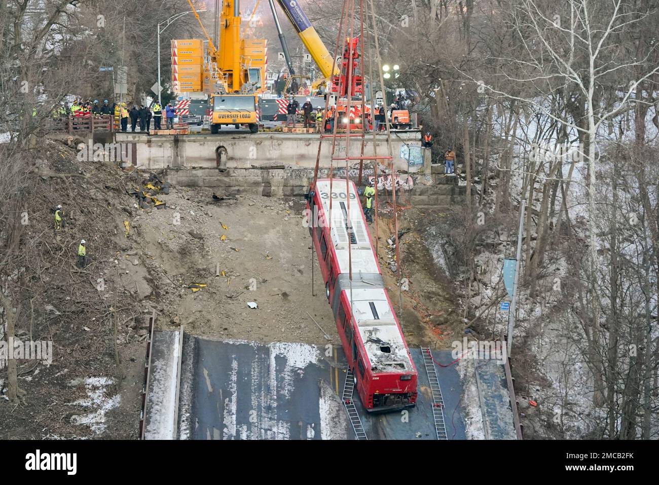 Cranes lift the bus that was on a bridge when it collapsed Friday ...