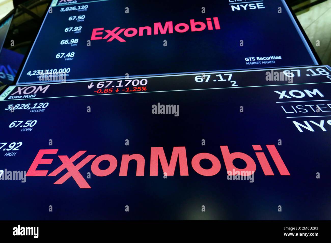 FILE - The logo for ExxonMobil appears above a trading post on the ...