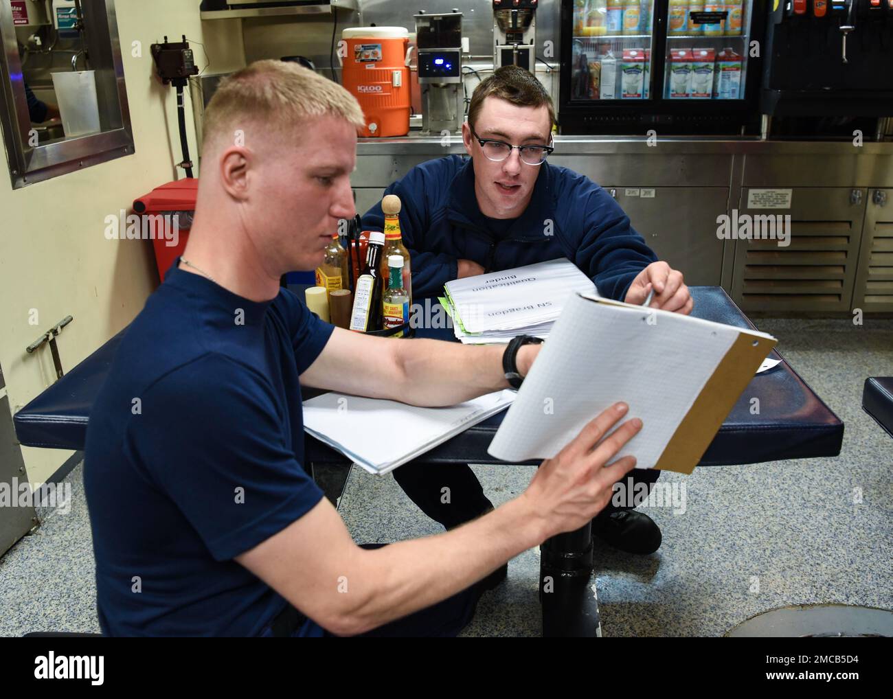 Seaman Mead Bragdon asks Petty Officer 3rd Class Benjamin Ziegler ...