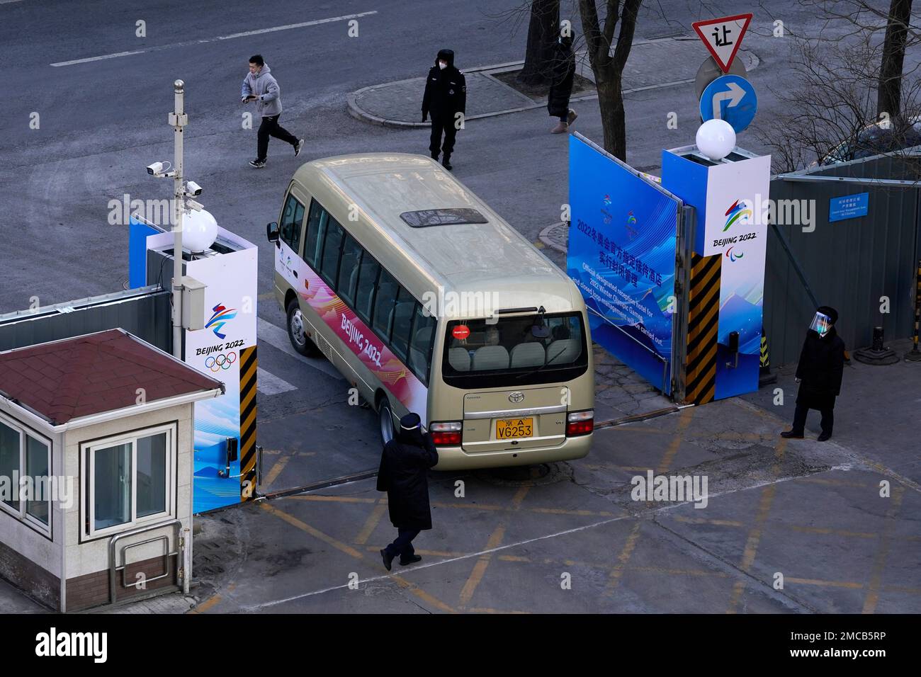 A bus is allowed through a security gate at a hotel inside the Olympic ...