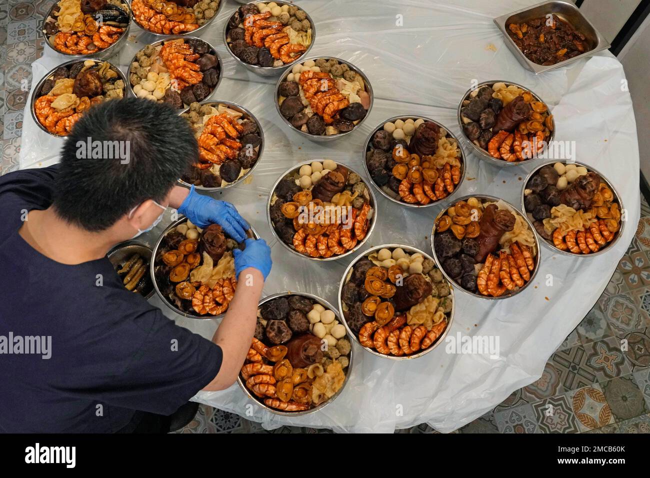Chef Fong Wah-yat prepares the "Poon Choi" dish at the RenRen Heping ...