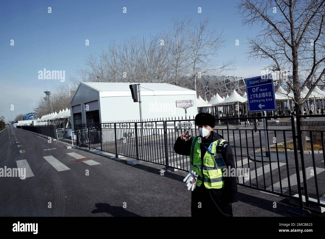 A security guard flashes the victory sign as he stands guard at the ...