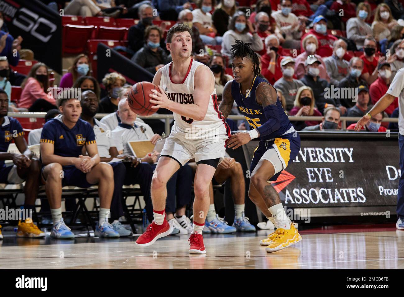 Davidson guard Foster Loyer (0) keeps the ball away from La Salle guard ...