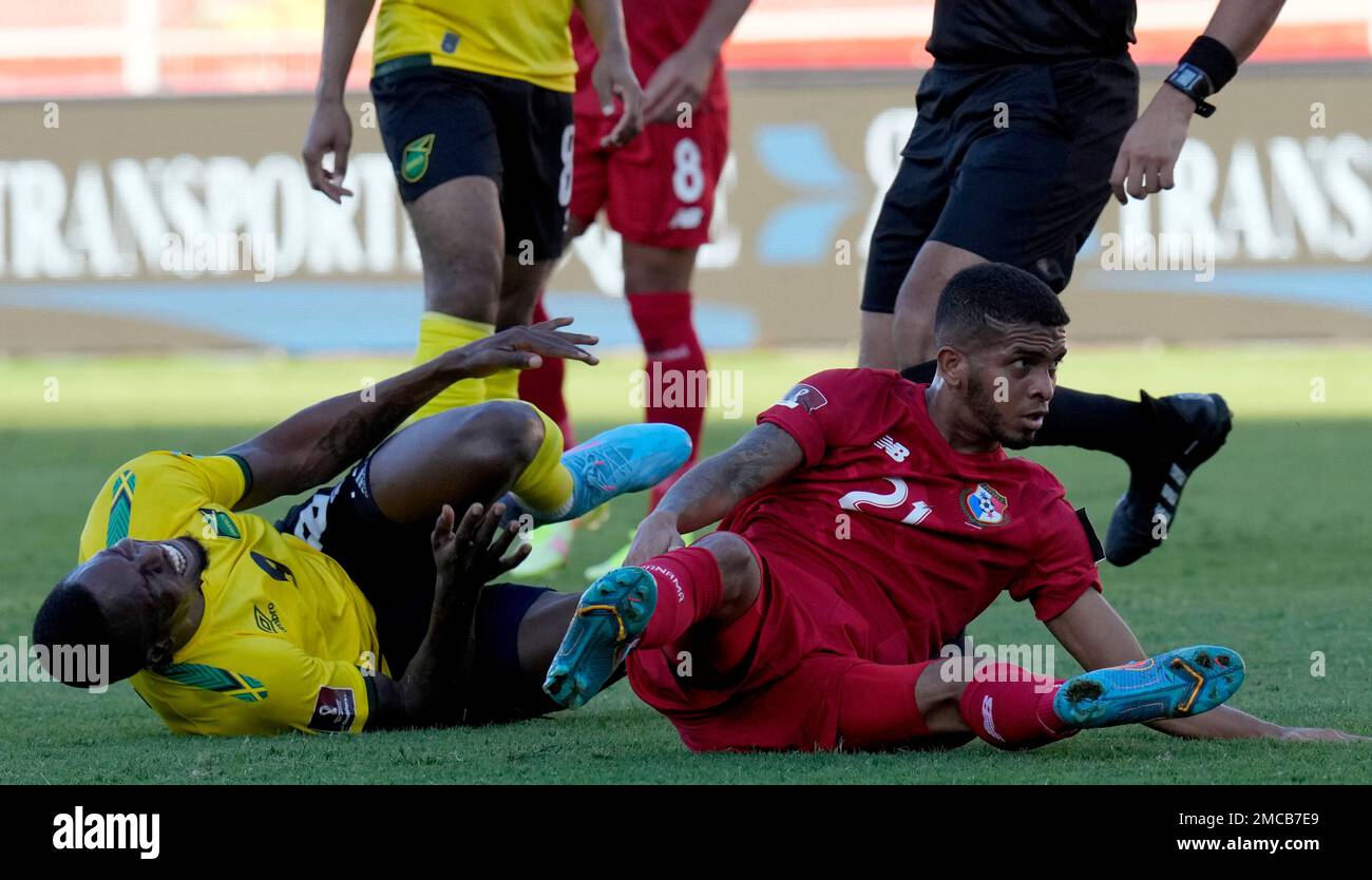Jamaica's Cory Burke, left, and Panama's Cesar Yanisroll on the pitch ...