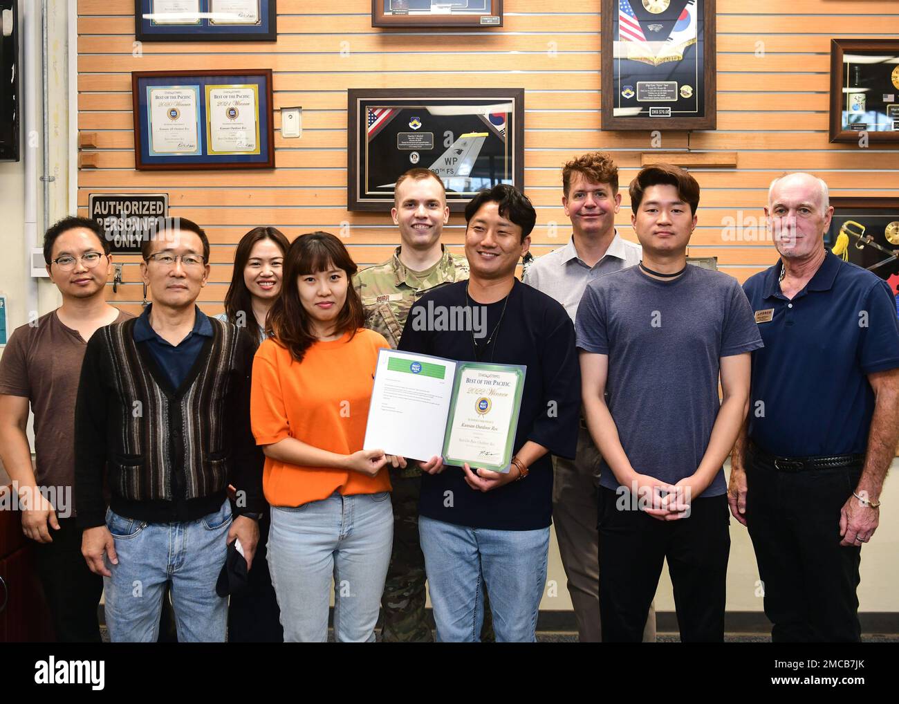 Staff from Outdoor Recreation accept an award inside their facility on ...