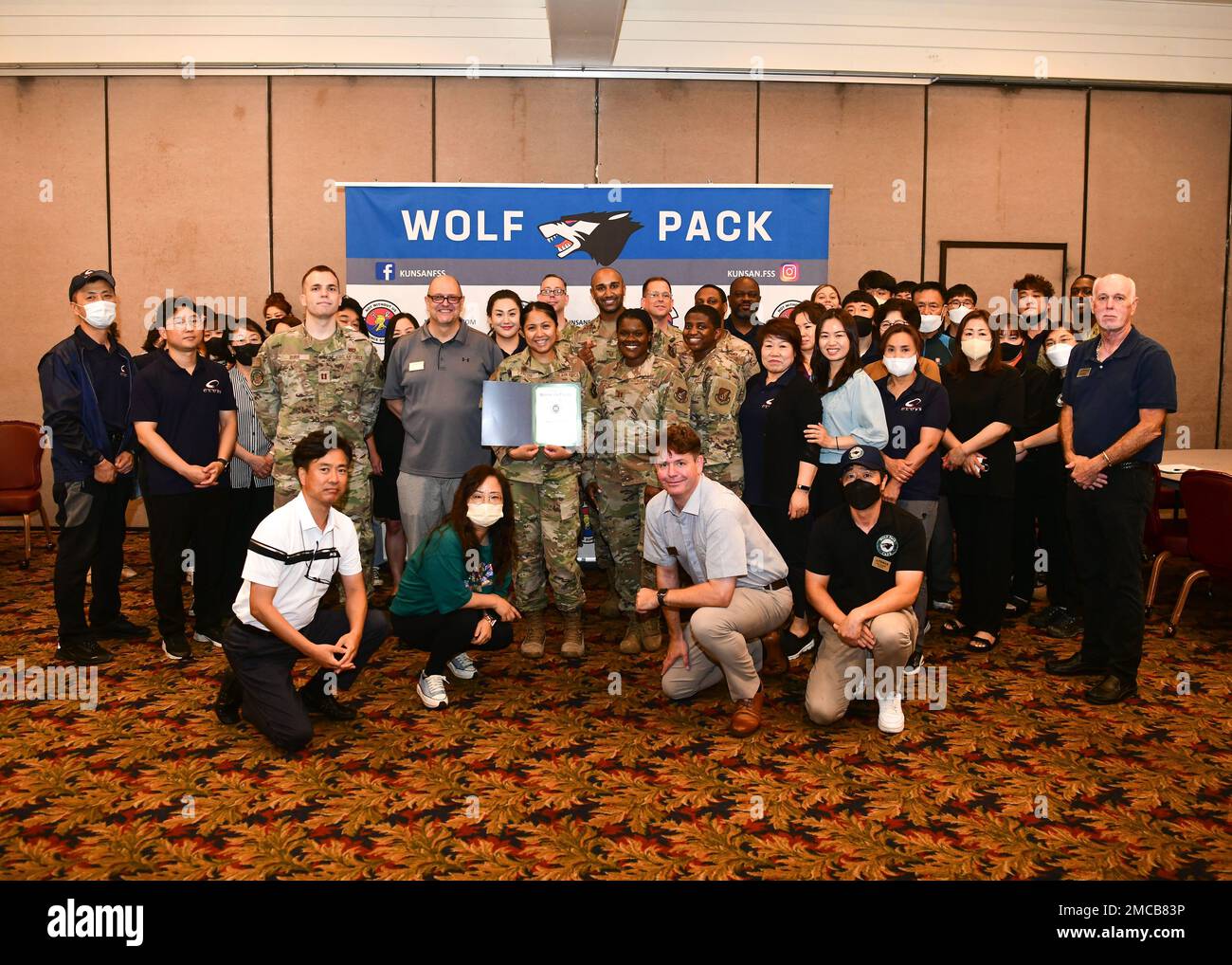 Airmen and staff from the 8th Force Support Squadron accept an award ...