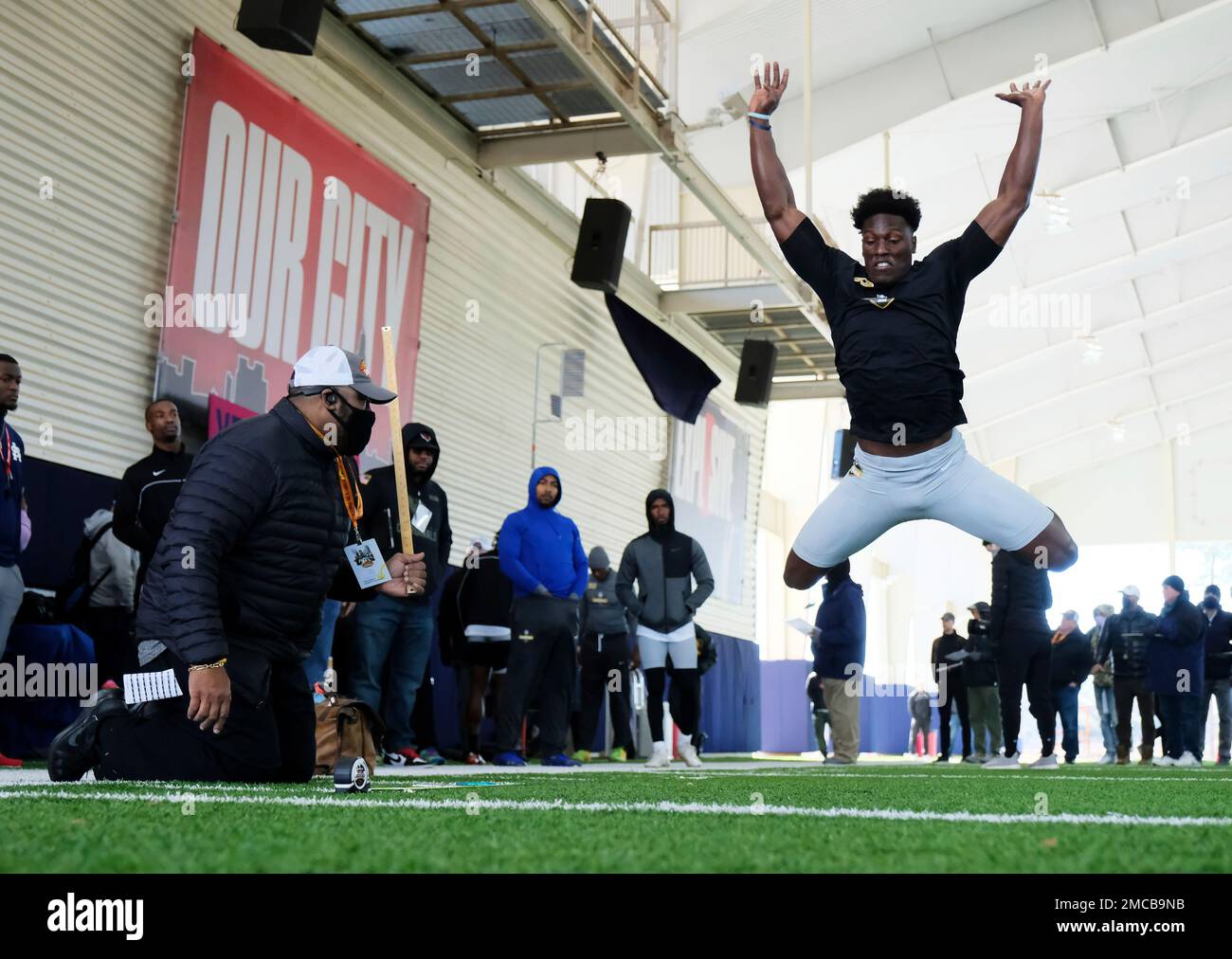 Southern wide receiver Marquis McClain, right, does a broad jump at the ...