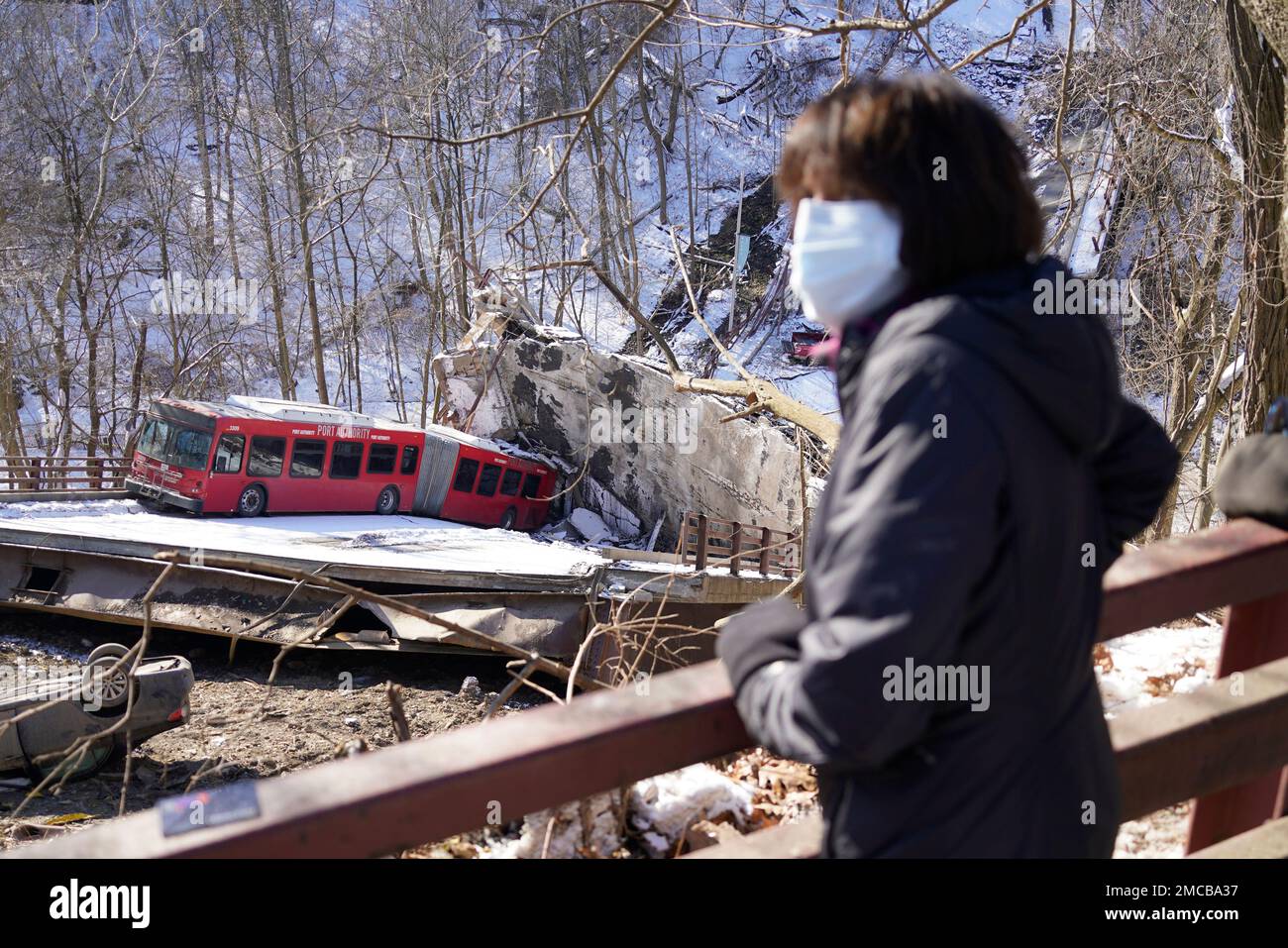Onlookers look at the bus and vehicles below after Friday's bridge ...