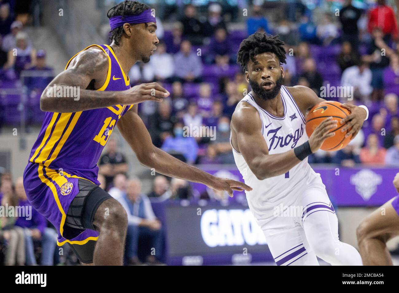 TCU guard Mike Miles, left, drives to the basket against LSU forward ...