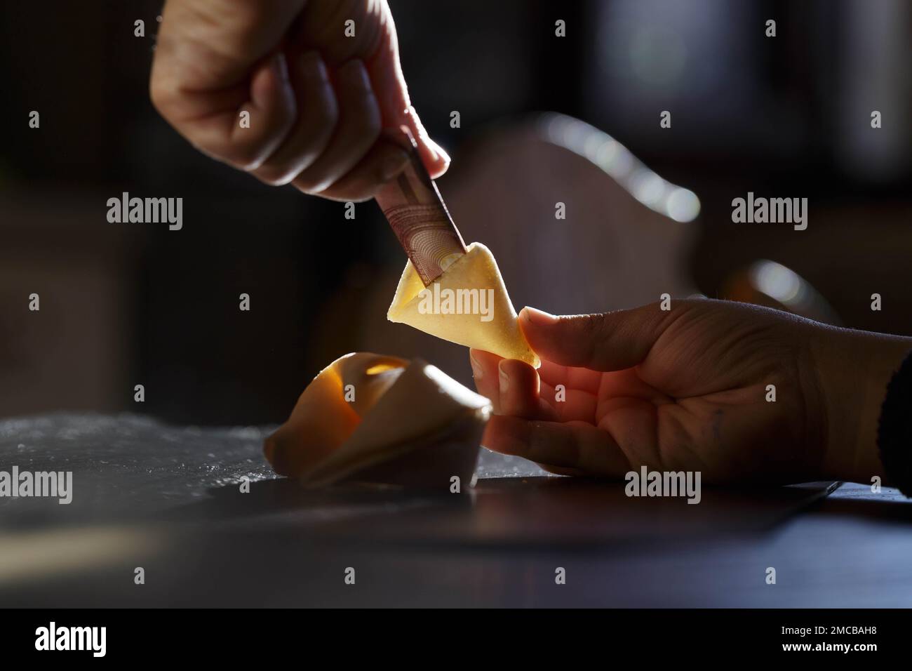 Inserting euro into cookie hi-res stock photography and images - Alamy
