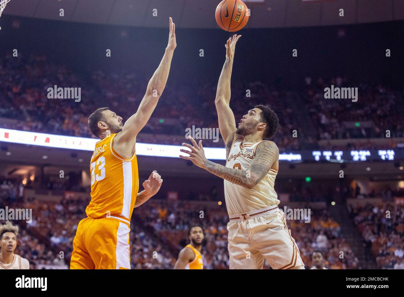 Texas forward Timmy Allen, right, looks to score over Tennessee forward ...