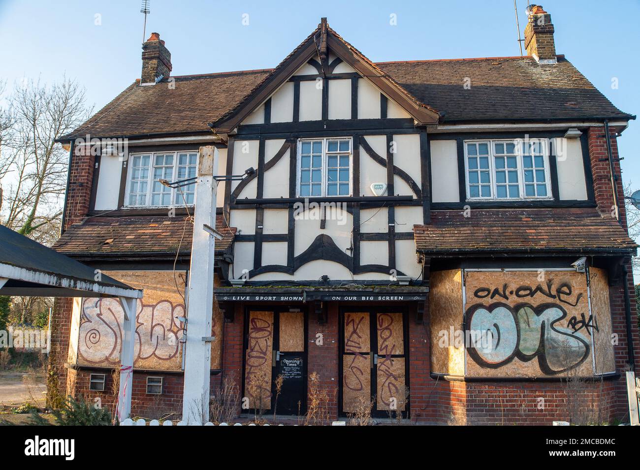 West Ruislip, UK. 21st January, 2023. A boarded up pub next to one of ...