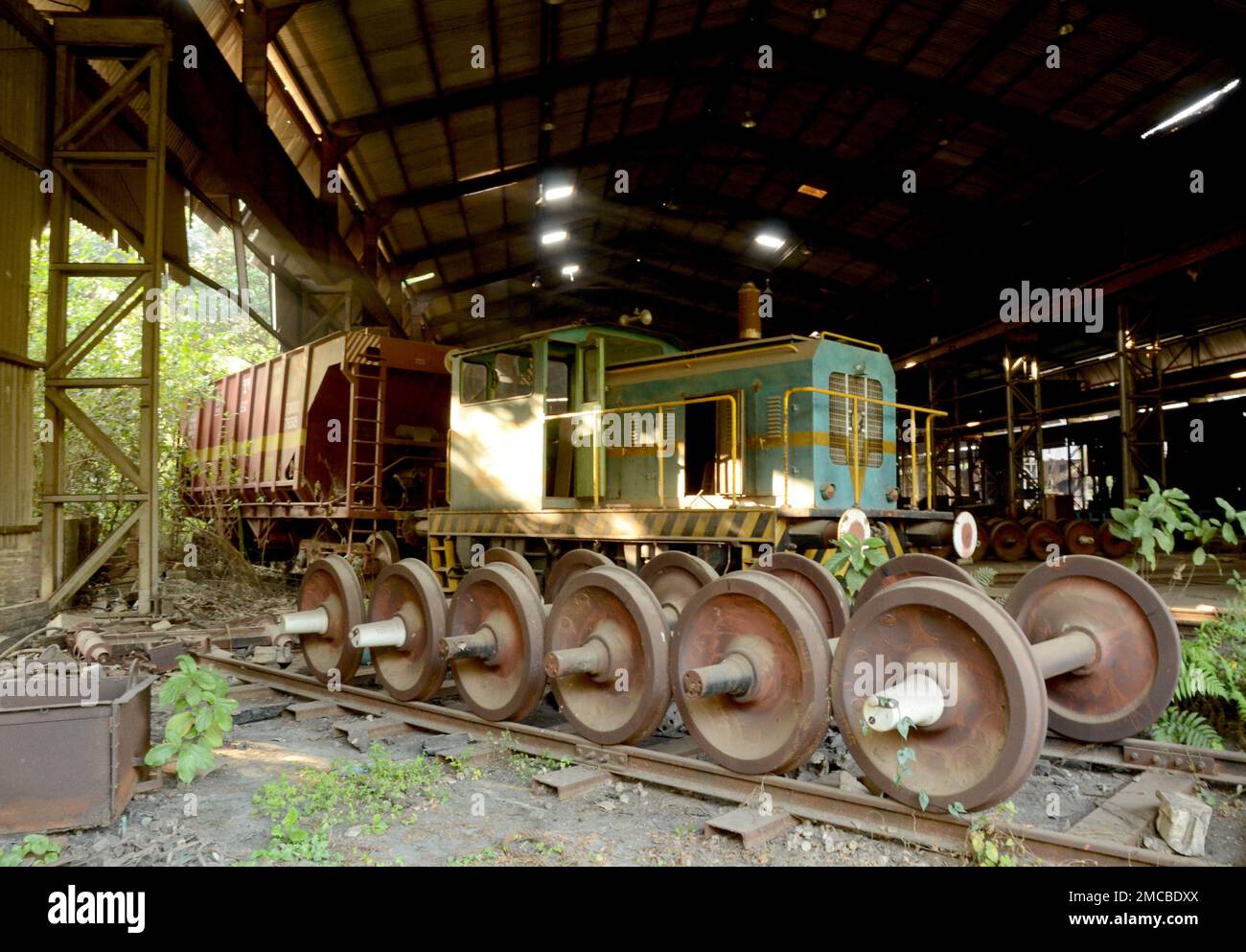 An old train wagon on an abandoned railway next to rusty train wheels ...