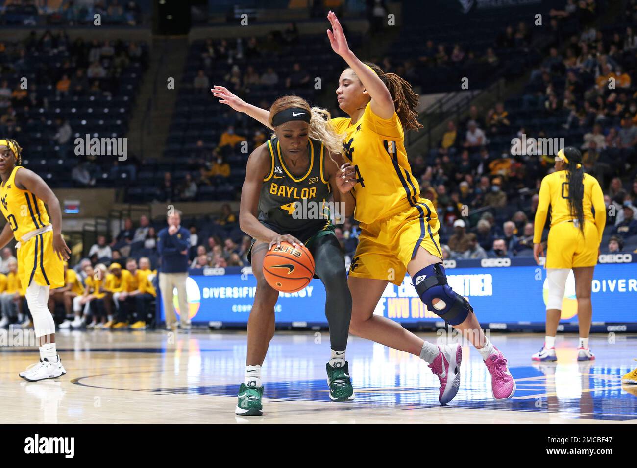 Baylor center Queen Egbo (4) is defended by West Virginia forward Kari ...