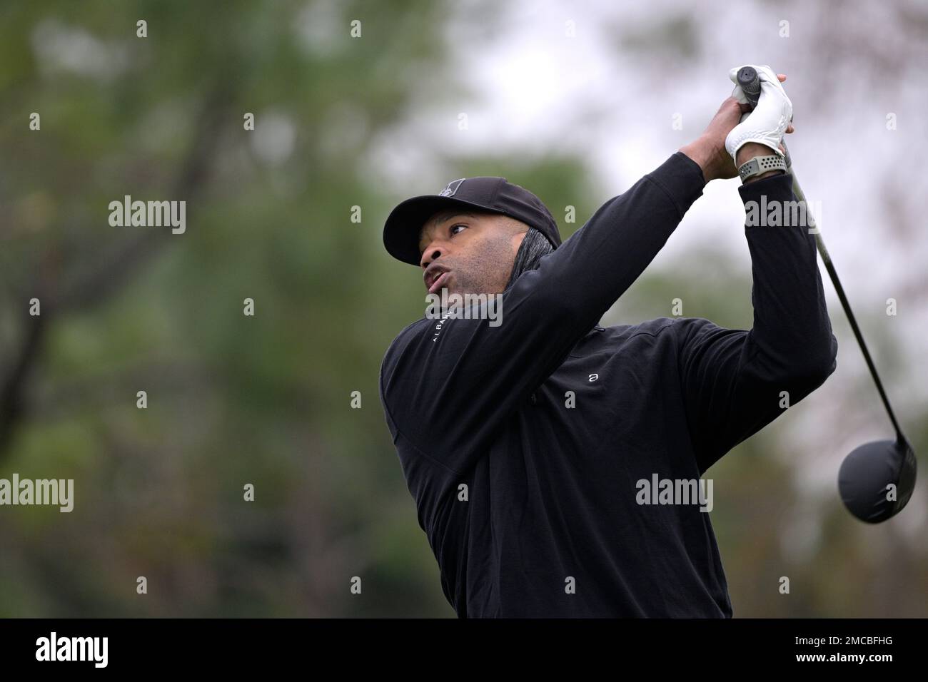 Former NBA basketball player Vince Carter tees off on the 11th hole ...