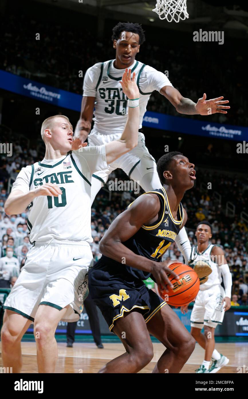 Michigan's Moussa Diabate, right, is defended by Michigan State's Joey ...