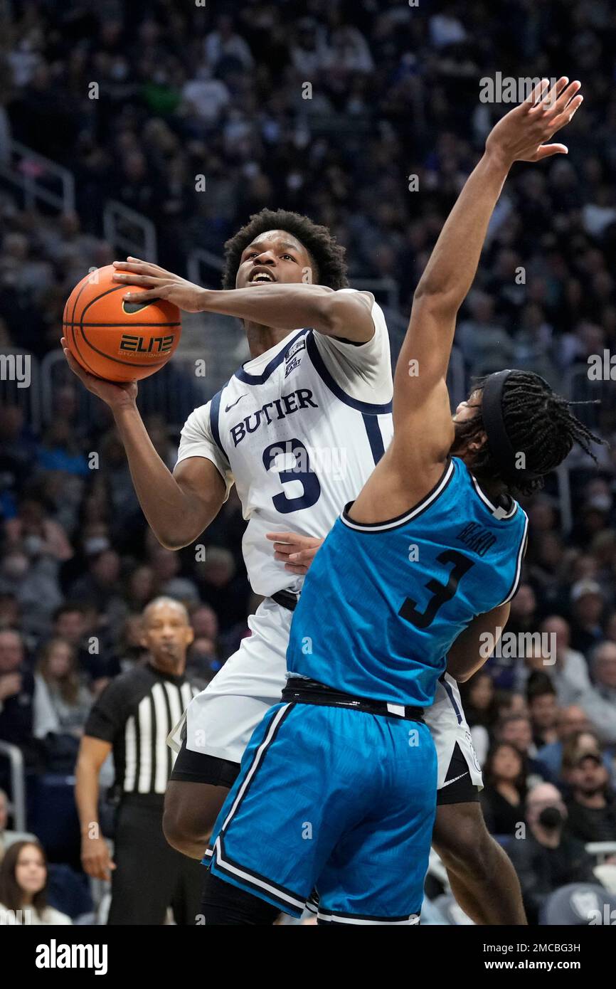 Butler guard Chuck Harris, left, shoots around Georgetown guard Tyler ...