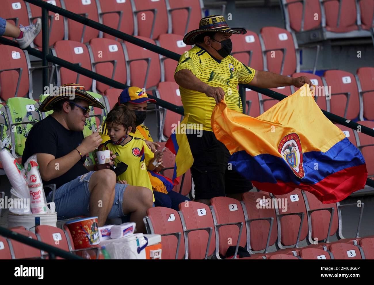 A Colombian fans waves his country's national flag while watching the ...