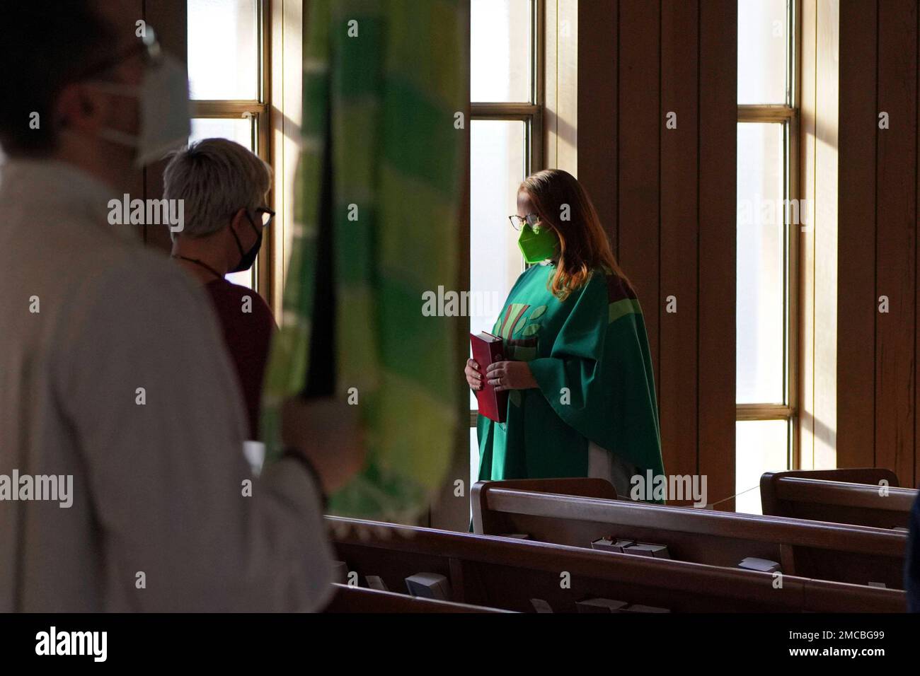 Lead Pastor Rev. Miriam Samuelson-Roberts, center, walks down an isle ...
