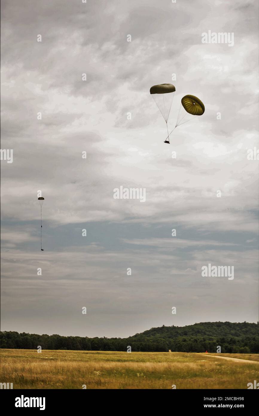 An airdrop bundle parachutes down after being released from a C-130 ...
