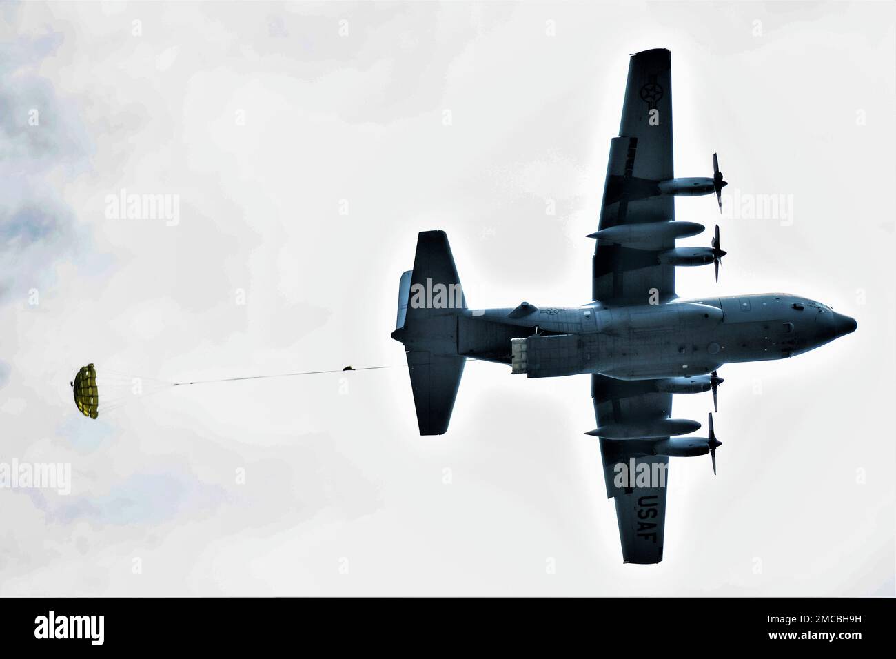 An airdrop is released from a C-130 Hercules on June 28, 2022, over a ...