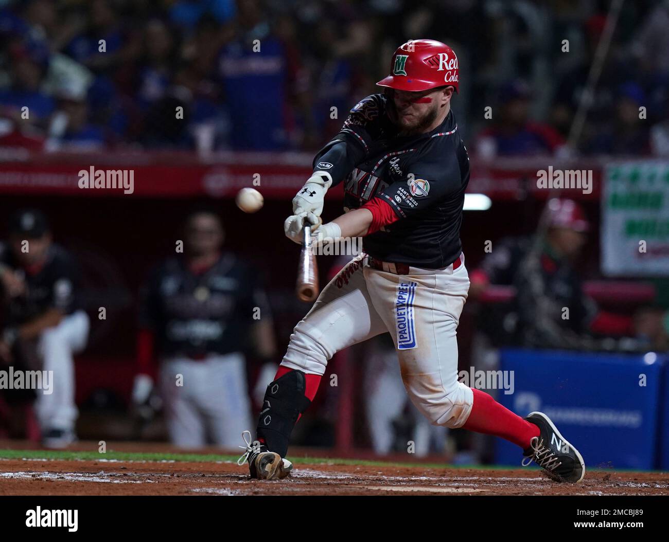 Mexico's baseman Jesus Quiroz connects a double against the Dominican ...