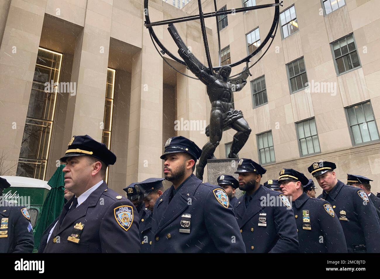 NYPD police officers stand in front of a statue of Atlas outside St ...