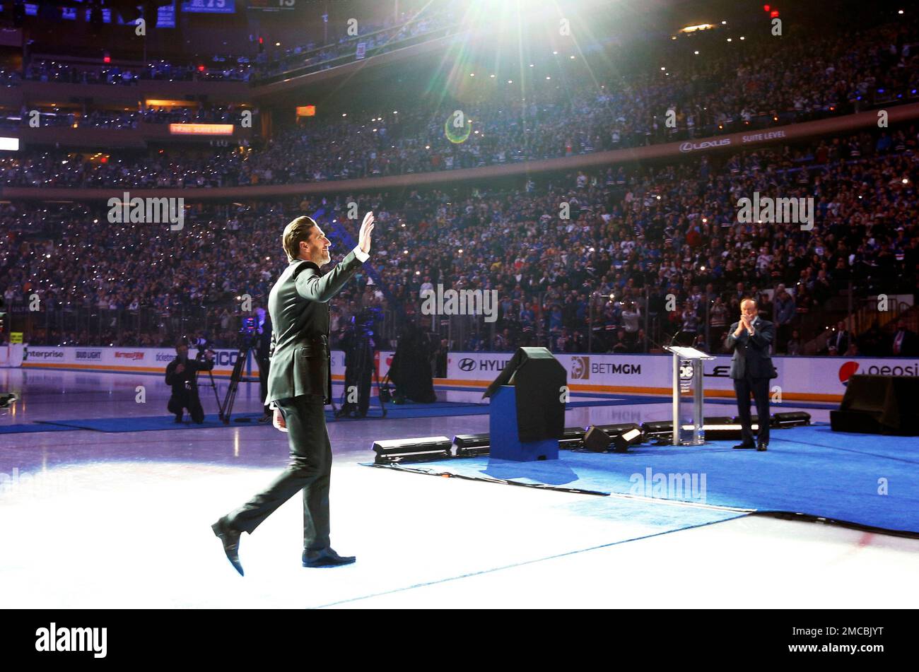 Former New York Rangers goaltender Henrik Lundqvist waves to the crowd ...