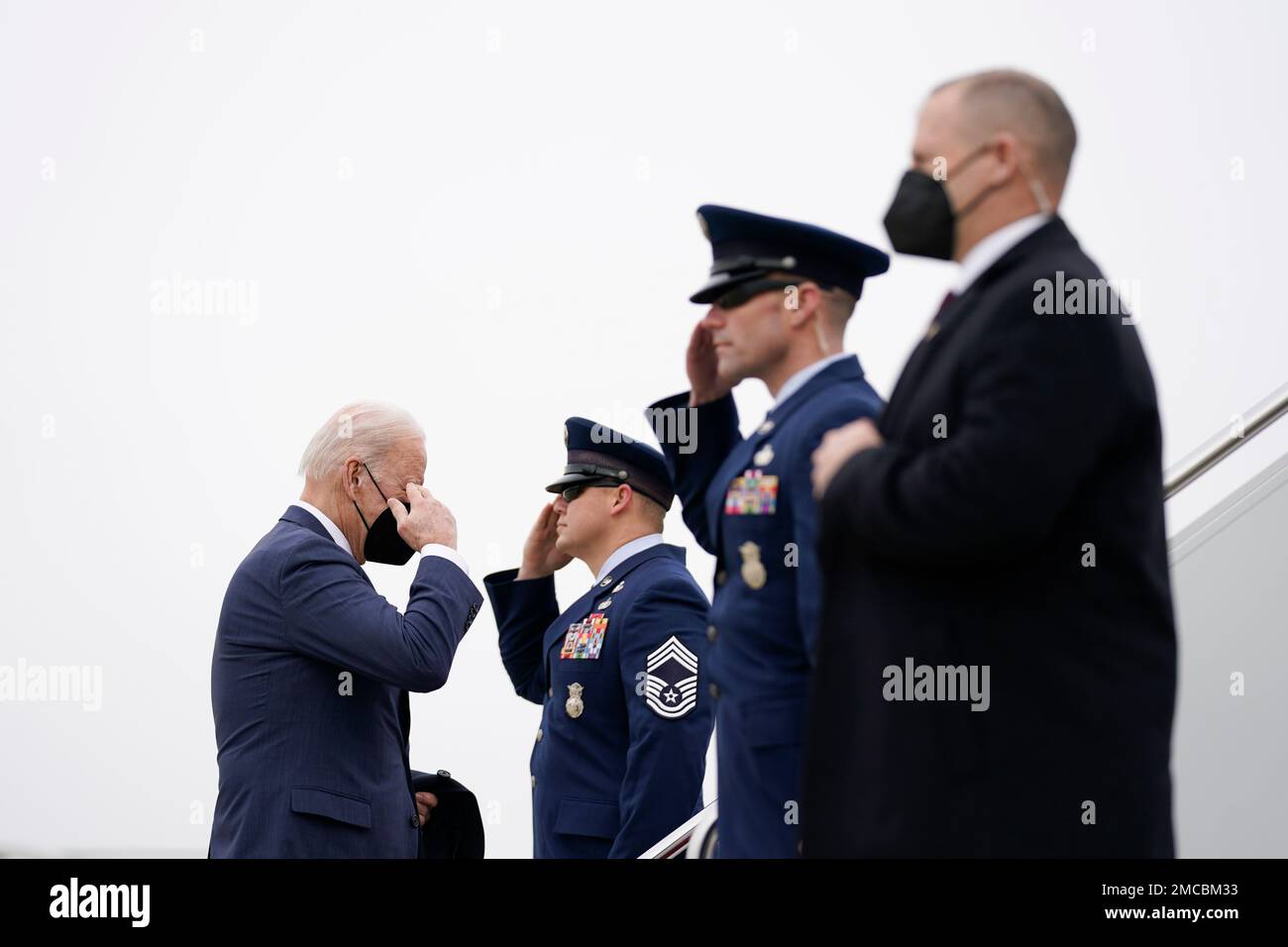 President Joe Biden returns a salute as he prepares to board Air Force ...