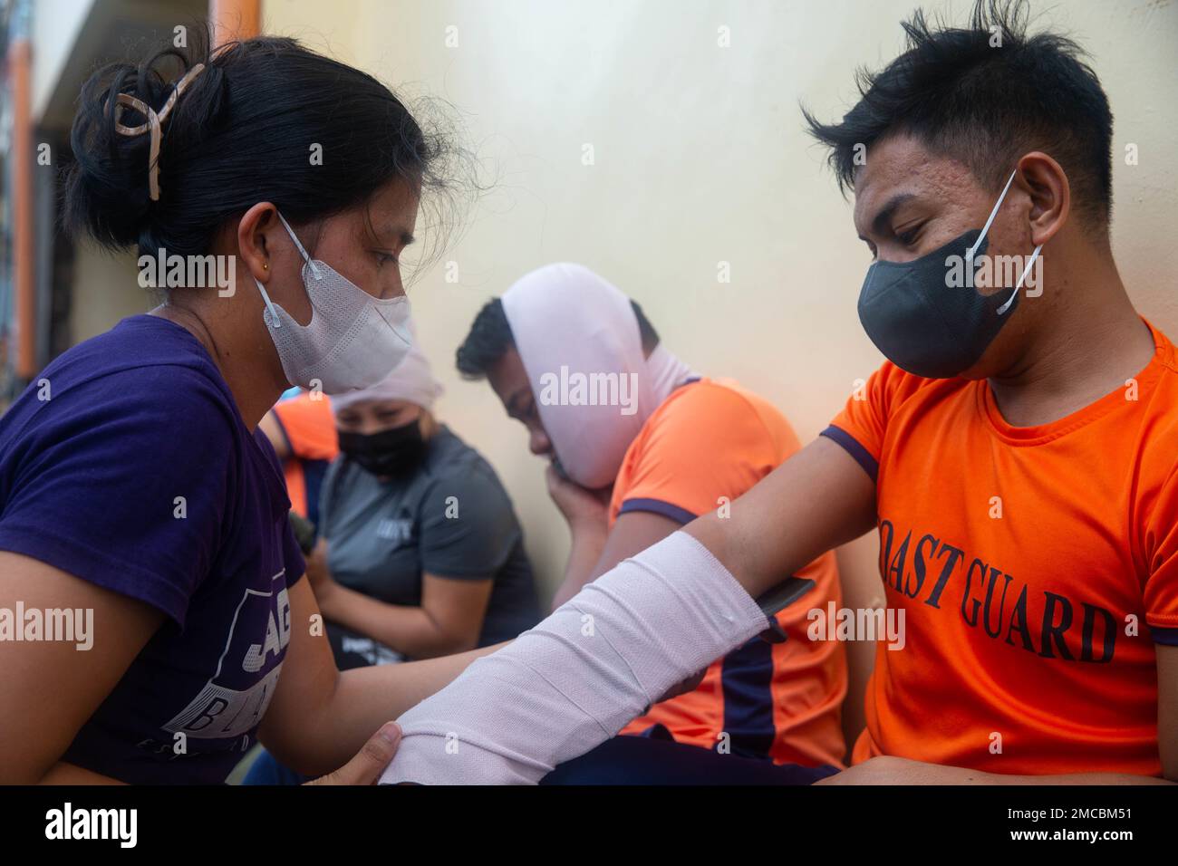A Batanes General Hospital nurse, left, applies a splint to the arm of ...