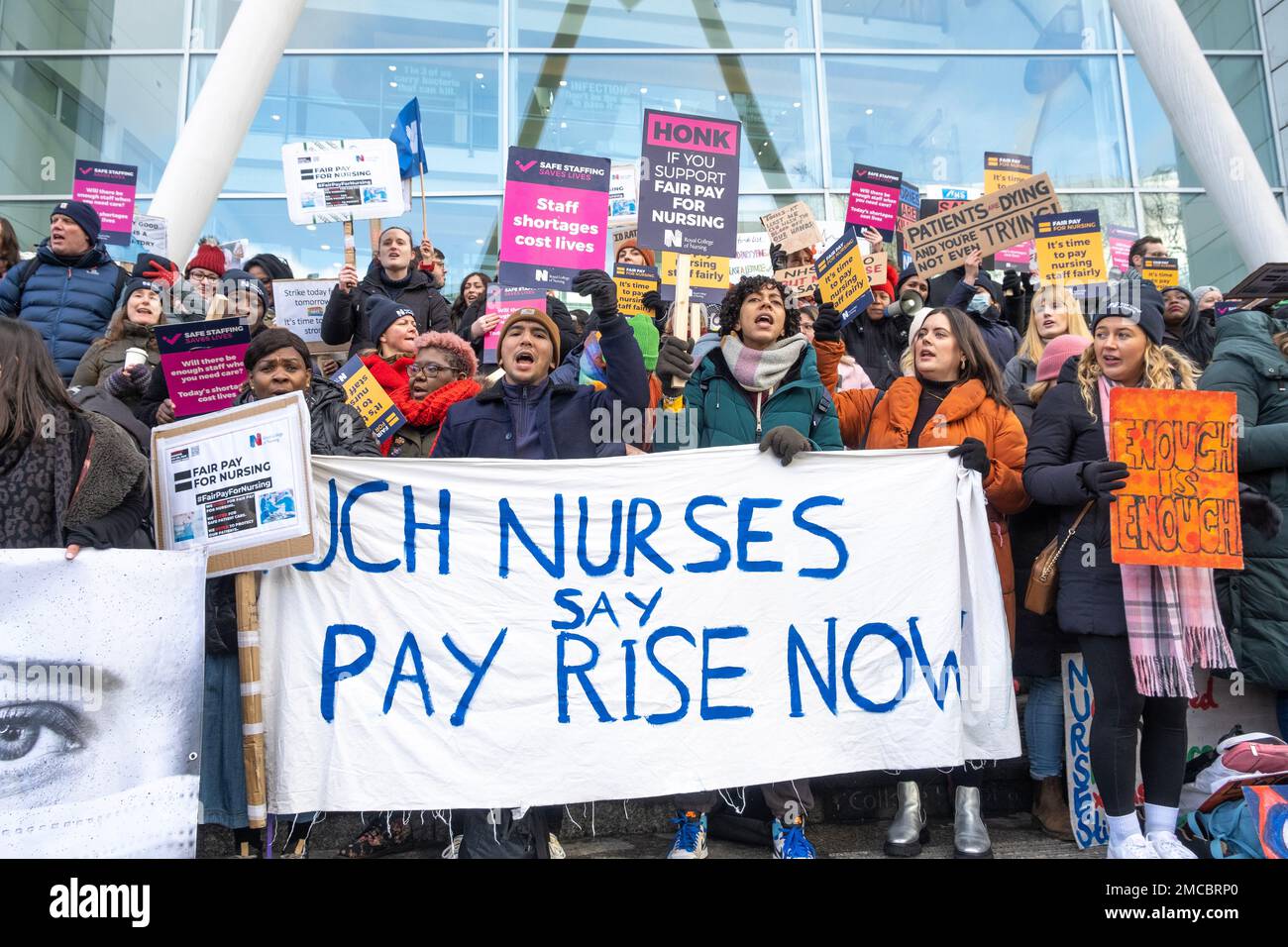 Striking nurses with placards, demonstrating outside University College ...