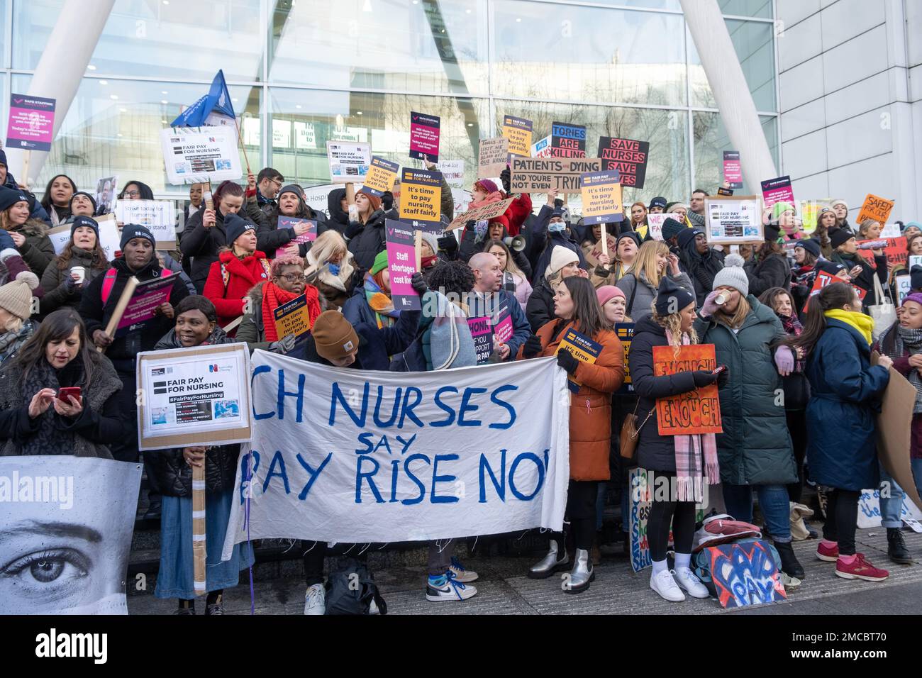 Striking nurses with placards, demonstrating outside University College ...