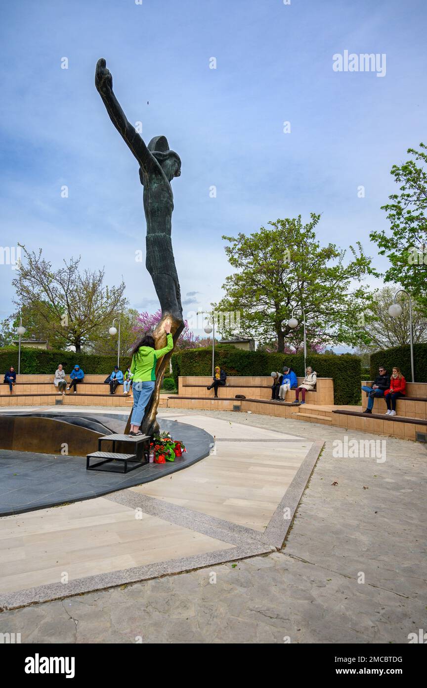 People venerating the statue of the Risen Christ in Medjugorje. The ...