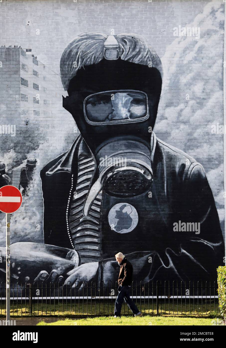 A man walks past a mural in the Bogside area of Londonderry, Northern ...