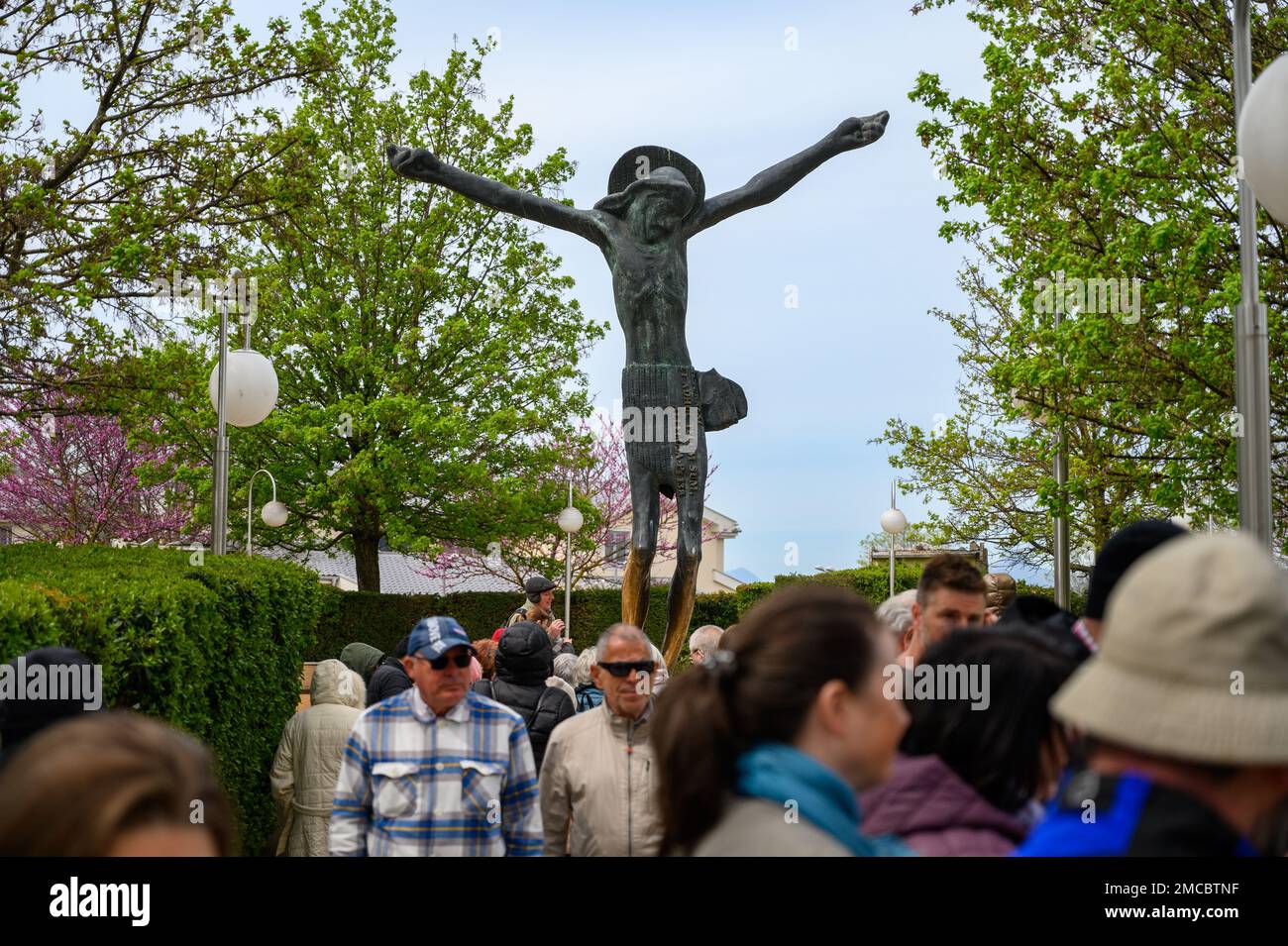 People venerating the statue of the Risen Christ in Medjugorje. The ...