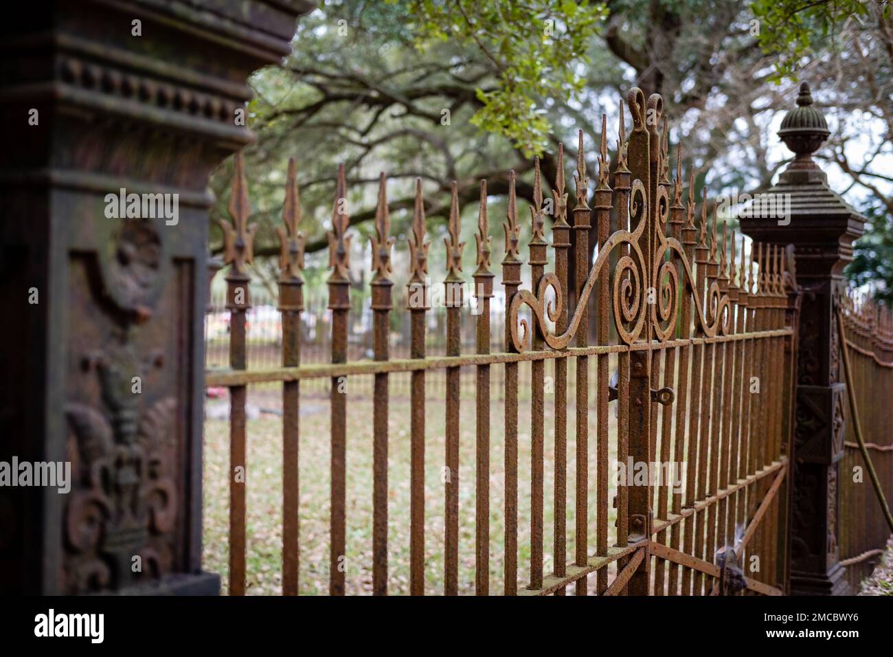 An old and historic small cemetery with headstones and rusted gates in ...