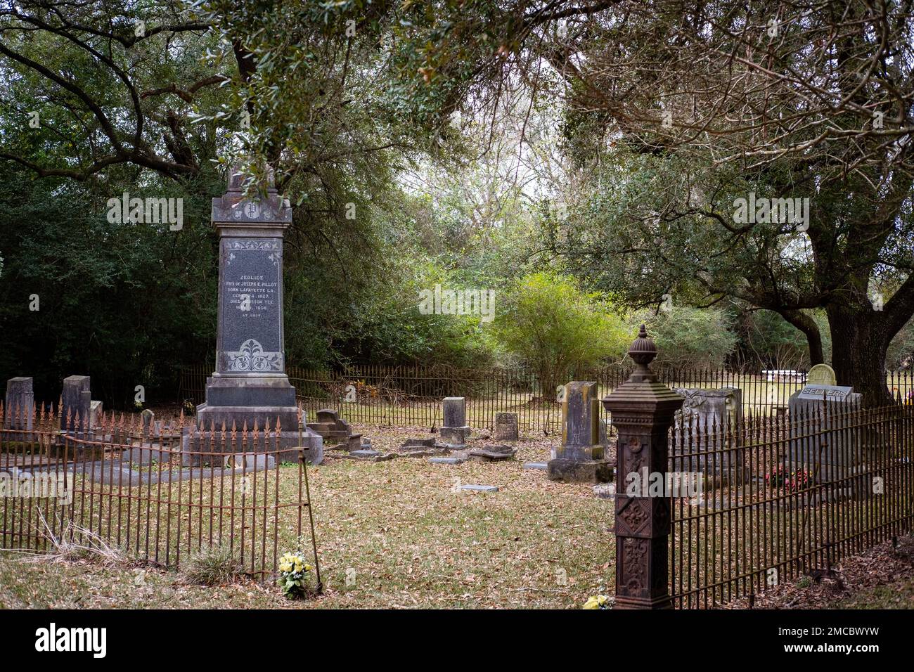 An old and historic small cemetery with headstones and rusted gates in ...