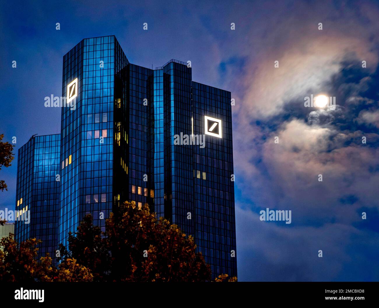 FILE — The moon shines next to the headquarters of the Deutsche Bank in ...