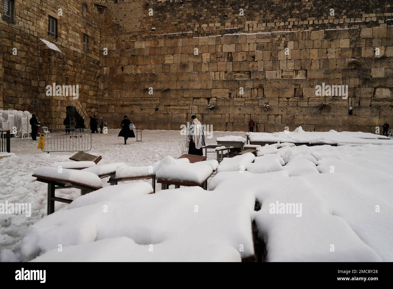 An ultra-Orthodox Jewish man stands in the snow while praying at the ...