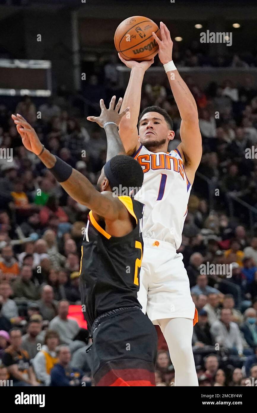 Phoenix Suns guard Devin Booker (1) shoots as Utah Jazz forward Royce O ...