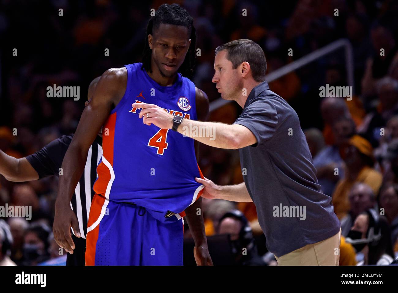 Florida head coach Mike White talks with forward Anthony Duruji (4 ...