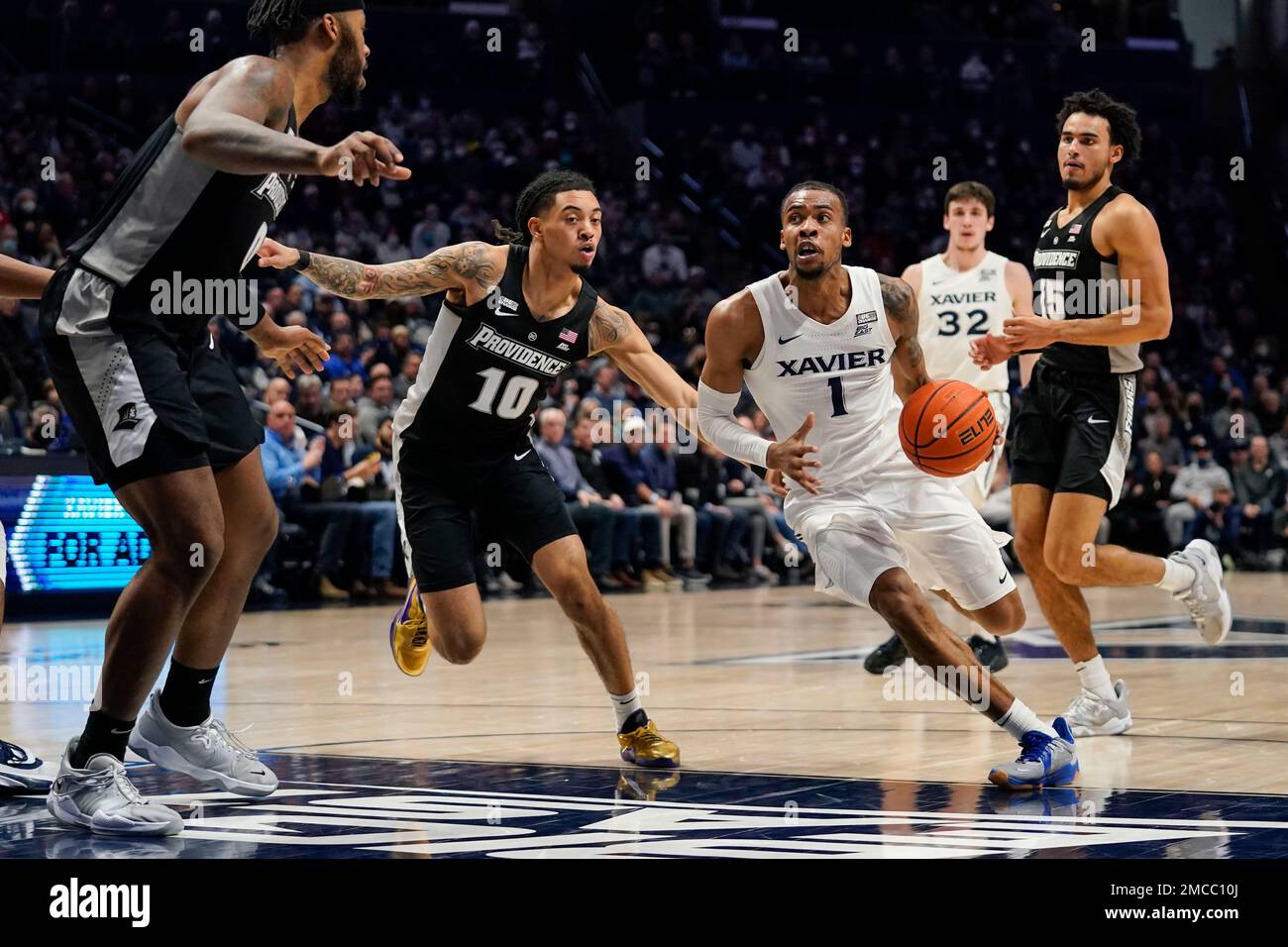 Xavier guard Paul Scruggs (1) drives past Providence's Alyn Breed (10 ...