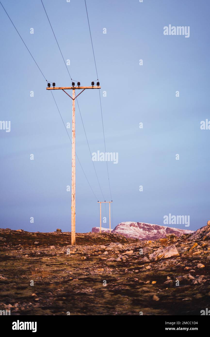 A vertical shot of an electric pole during polar night, Tromso, Norway ...